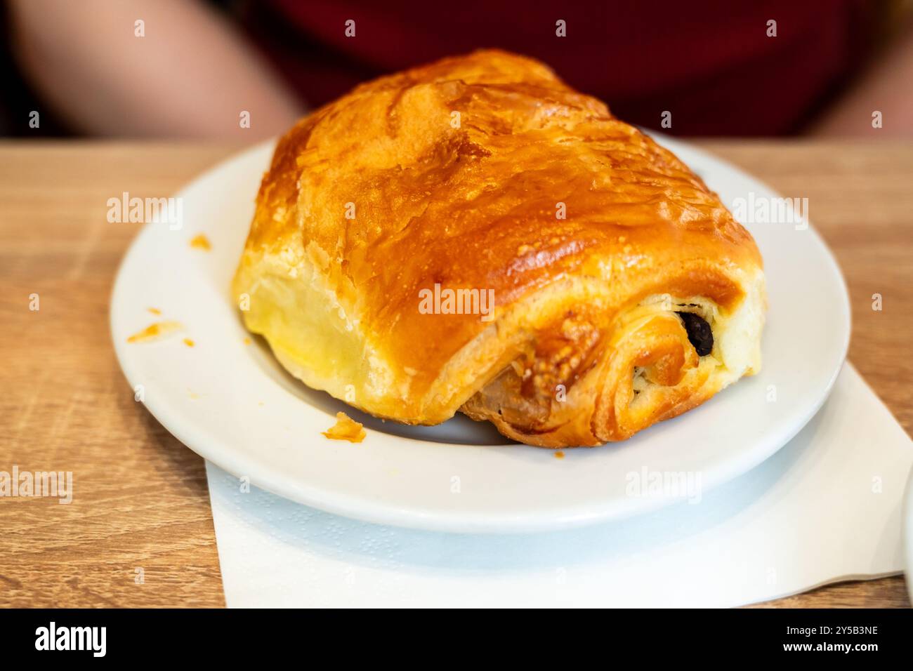 chocolate croissant 0pain au chocolat) on a plate in a a bakery ...