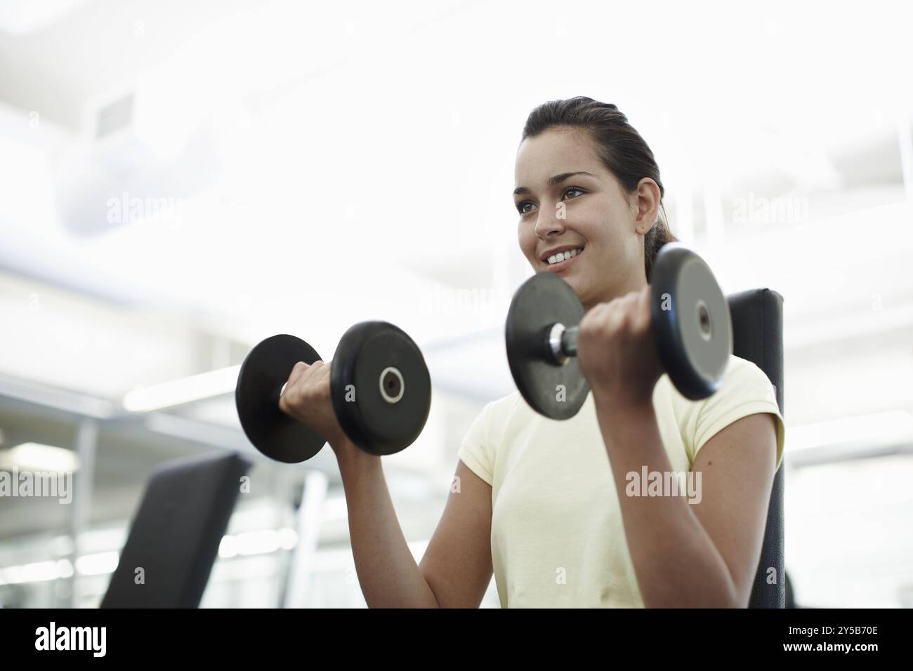 Fitness, smile and woman with weights in gym for bodybuilding, exercise ...