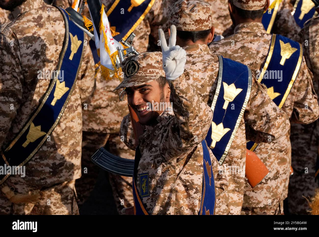 A member of the Iranian Revolutionary Guard flashes a victory sign ...