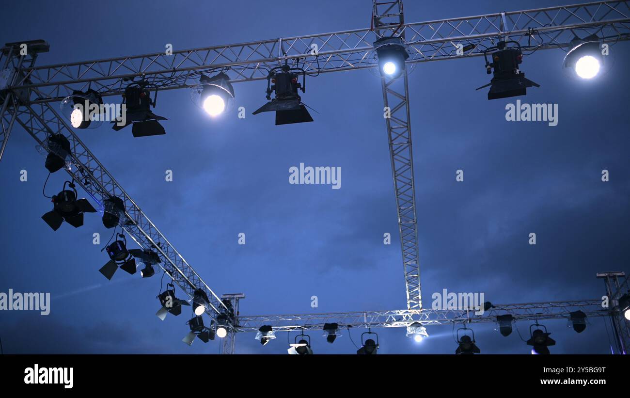 Stage lights suspended above a performance space create an ambiance ...