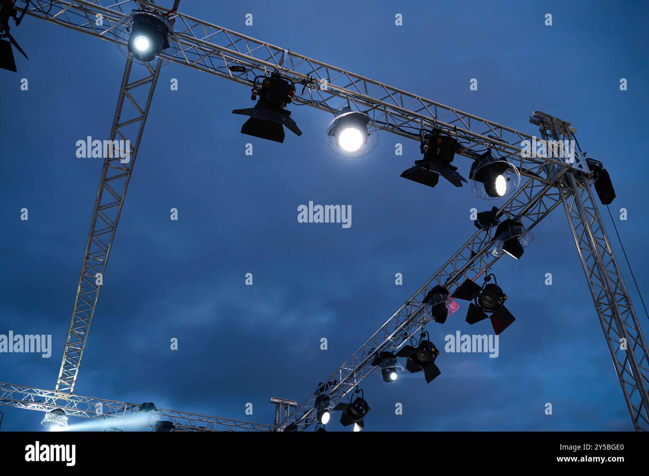 Stage lights suspended above a performance space create an ambiance ...