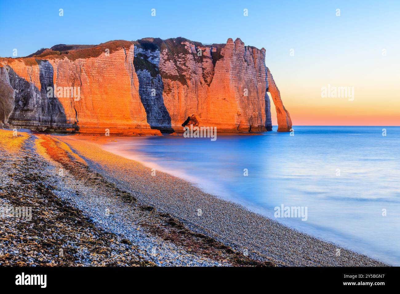 Normandy, France. Etretat village cliffs with the Porte d'Aval arch and ...