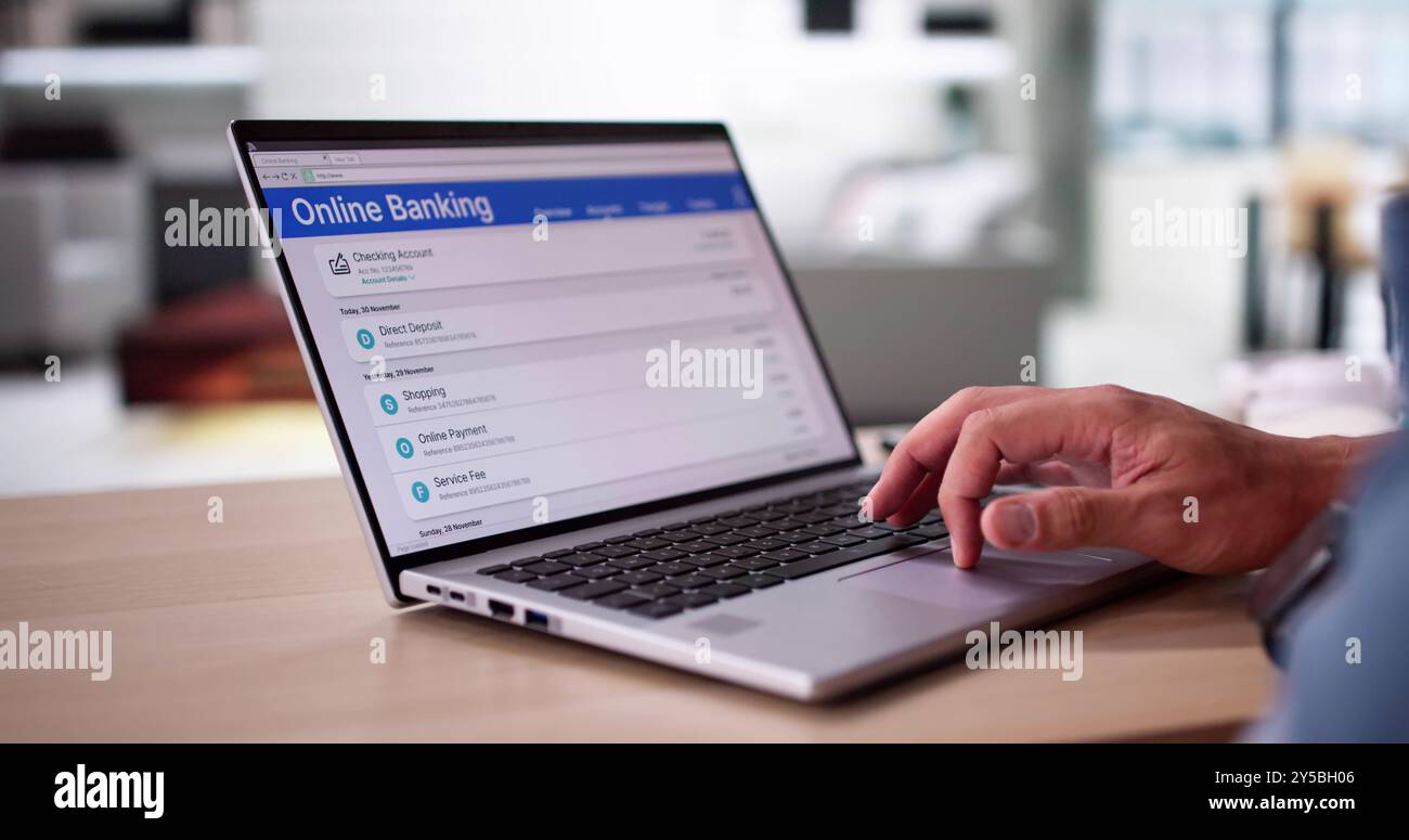 Checking Bank Account On Laptop. Man Making Payment Stock Photo - Alamy