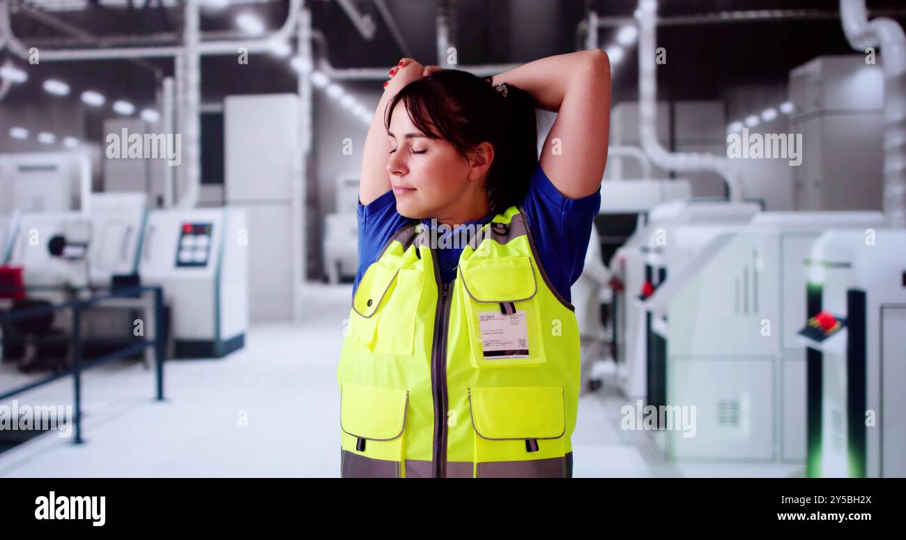 Stretch Arm Exercises While Working At Factory Stock Photo - Alamy