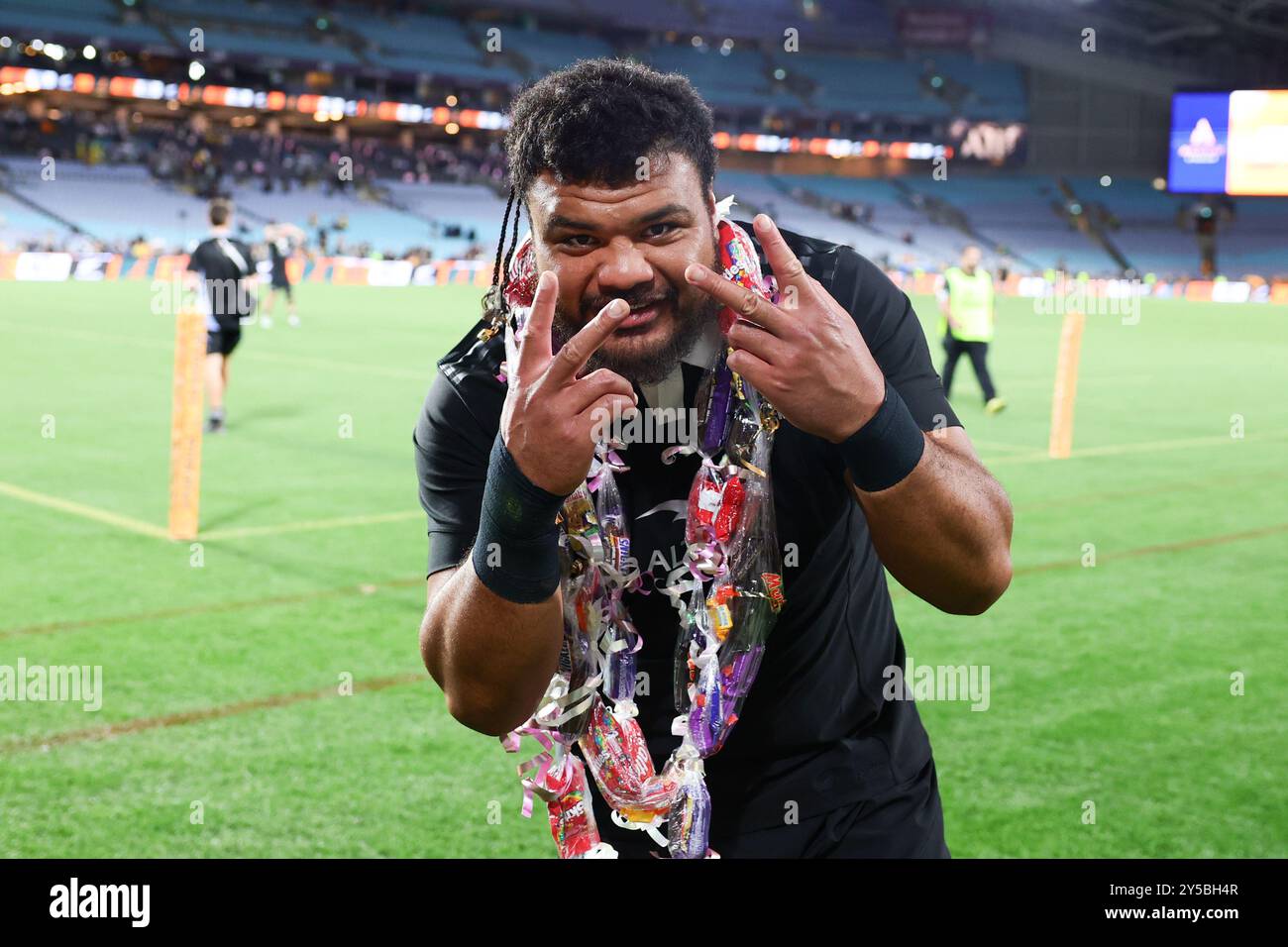 Pasilio Tosi of the All Blacks gives the peace sign after winning the ...