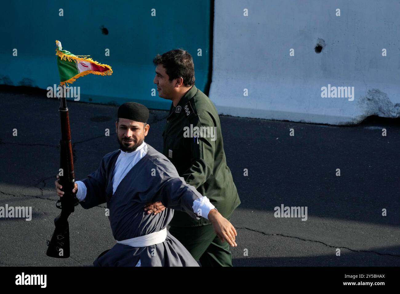A member of the Iranian paramilitary Basij force, wearing a traditional ...