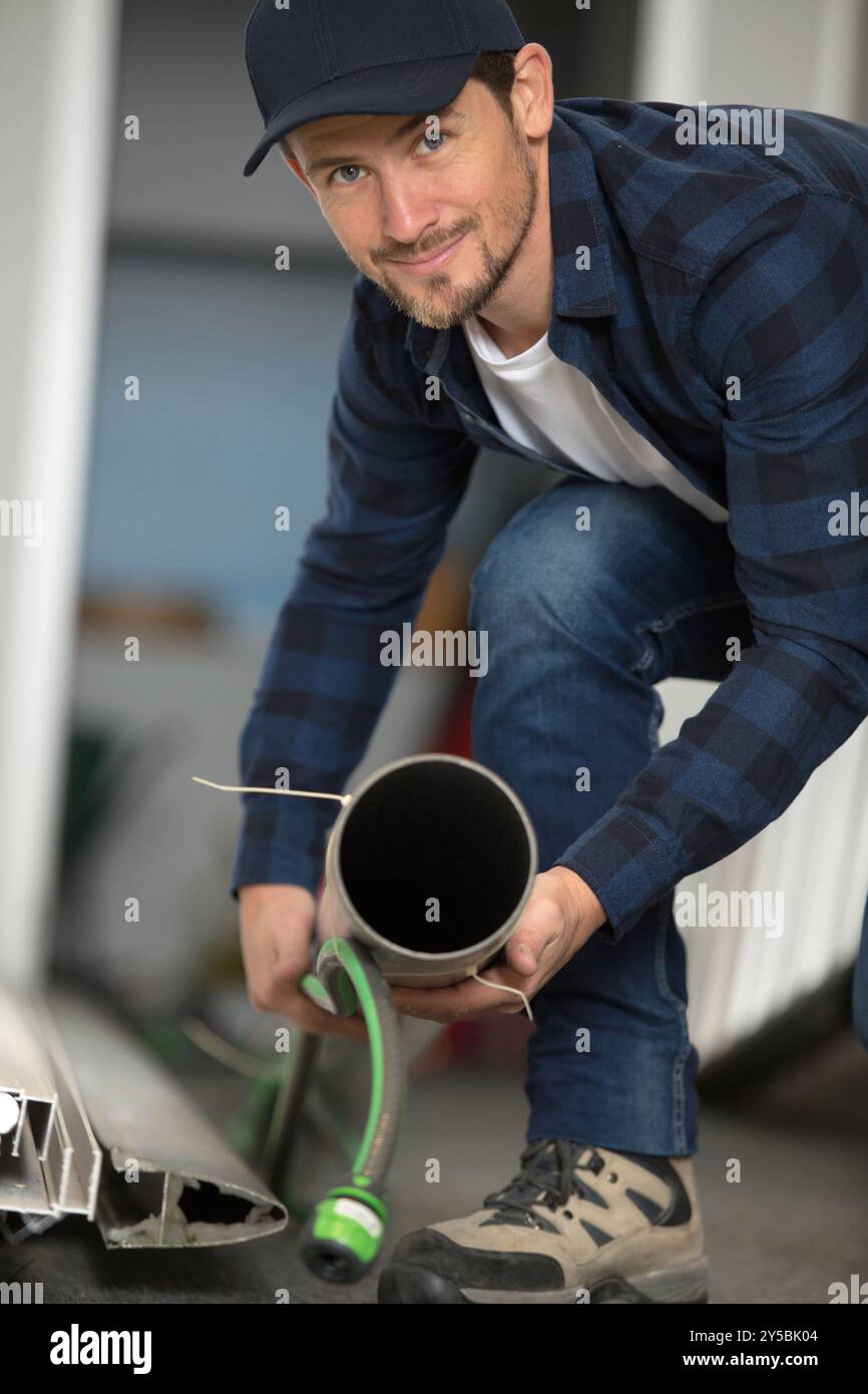 worker is repairing a pipe Stock Photo - Alamy