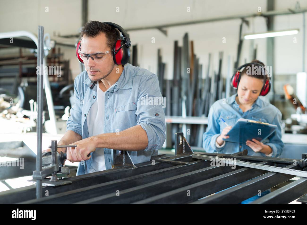metalworker man and woman in factory Stock Photo - Alamy