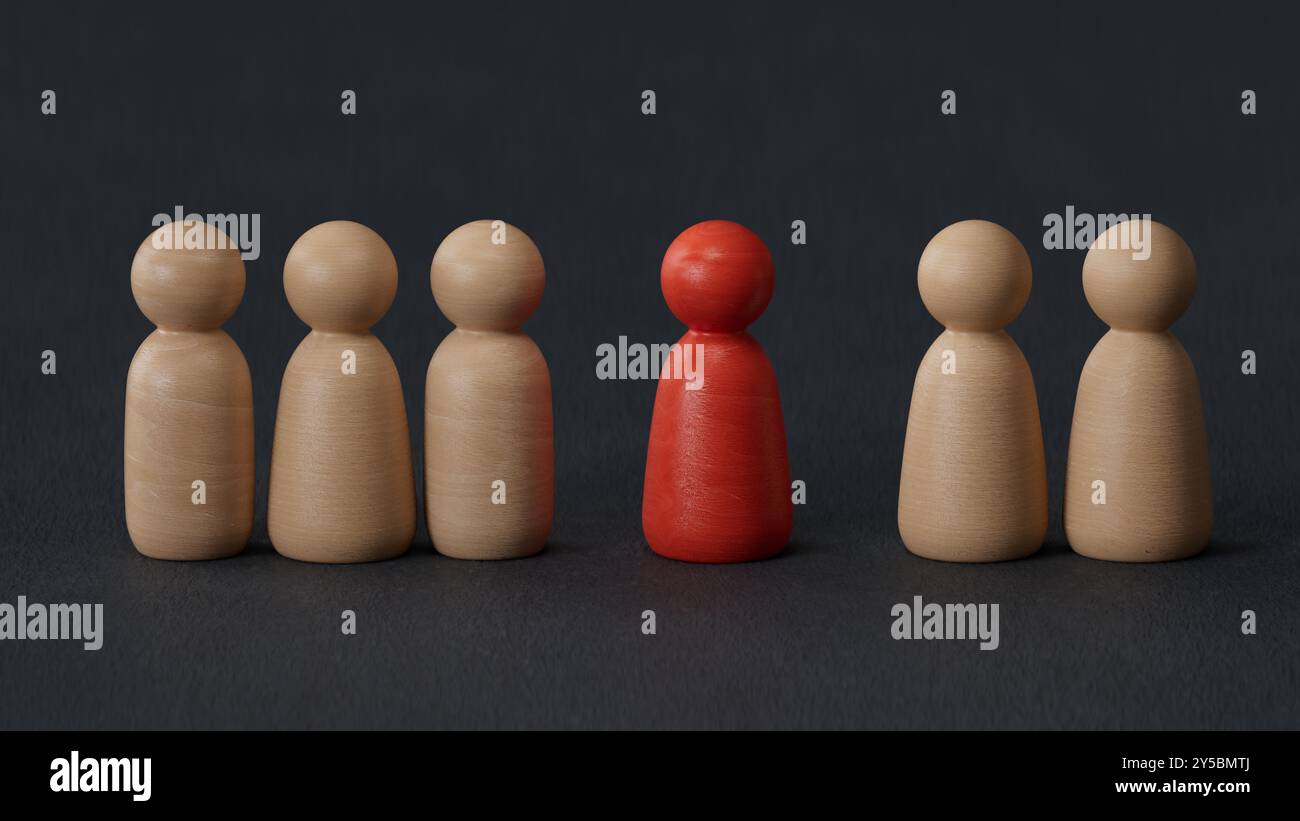 Wooden figure standing with team to show influence and empowerment ...