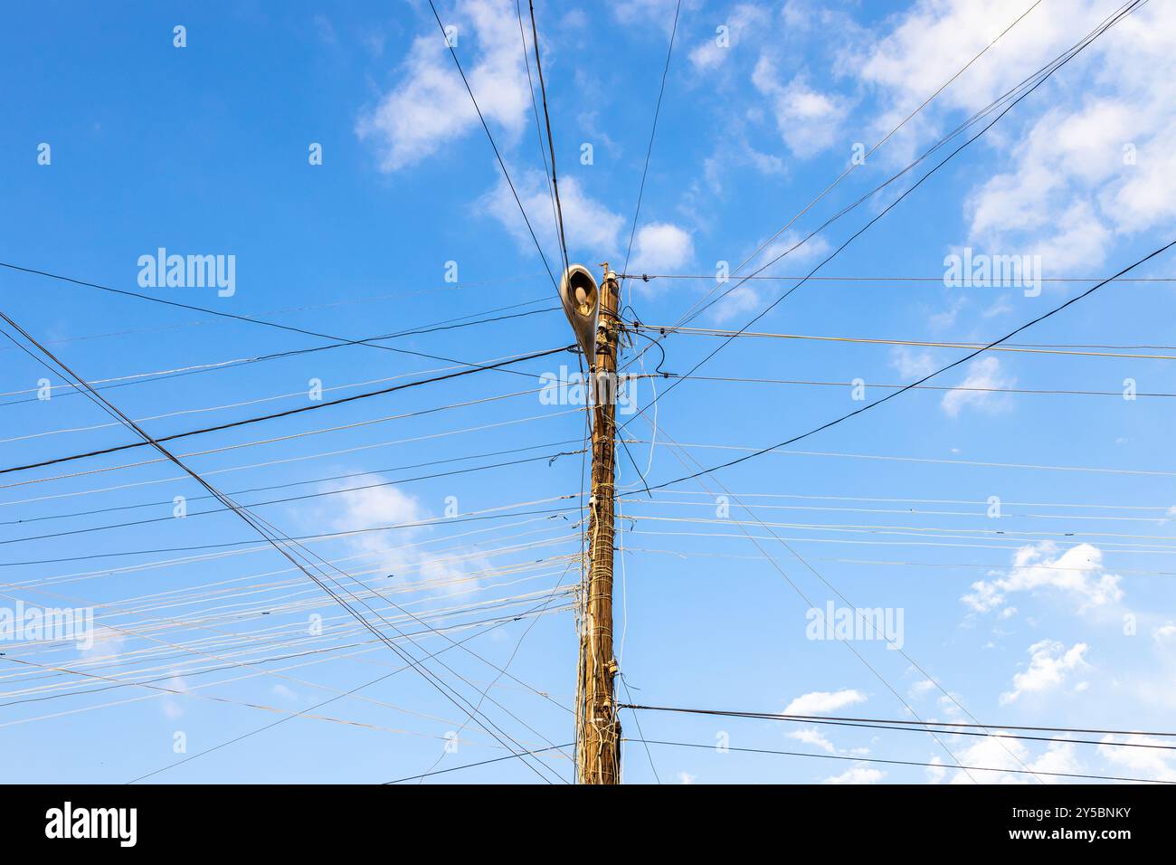 street lamp pole with many tangled electrical wires and dome of ...