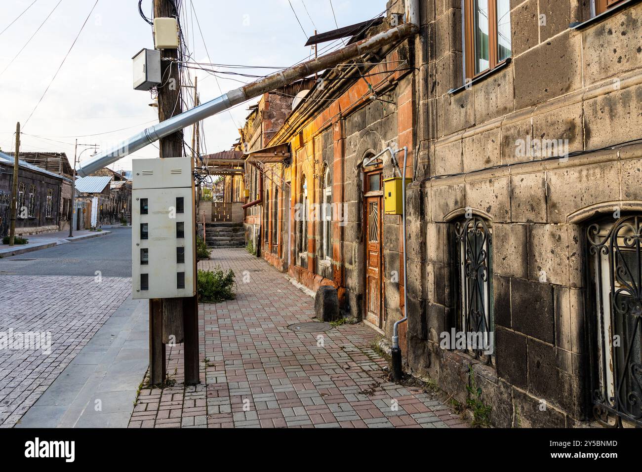 long drainpipe from roof of residential building lying on case with ...