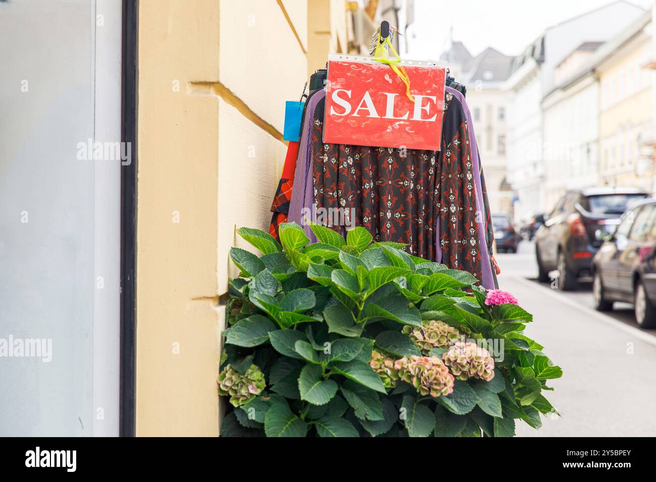 Dresses on sale outside a clothing store, colorful shopping display ...