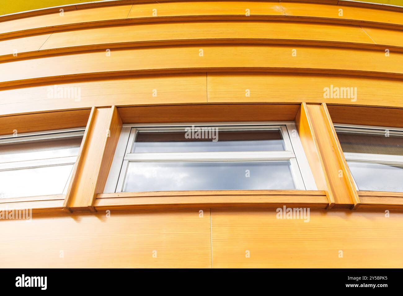 Geometric design, modern wooden facade with rectangular windows and ...