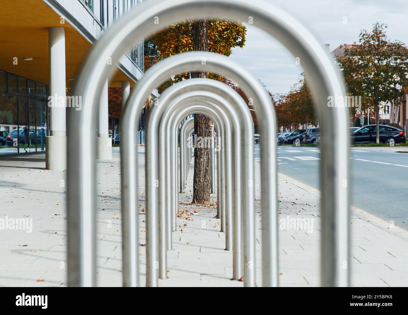 Symmetrical line of metal bike racks on city street sidewalk ...