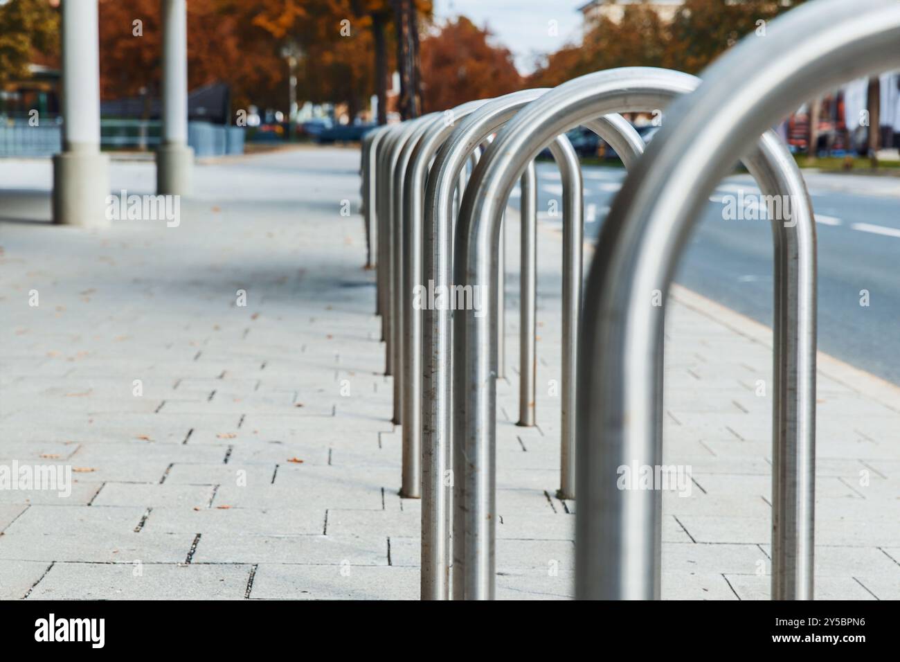 Modern row of metal bike racks on urban street, a parking area for ...