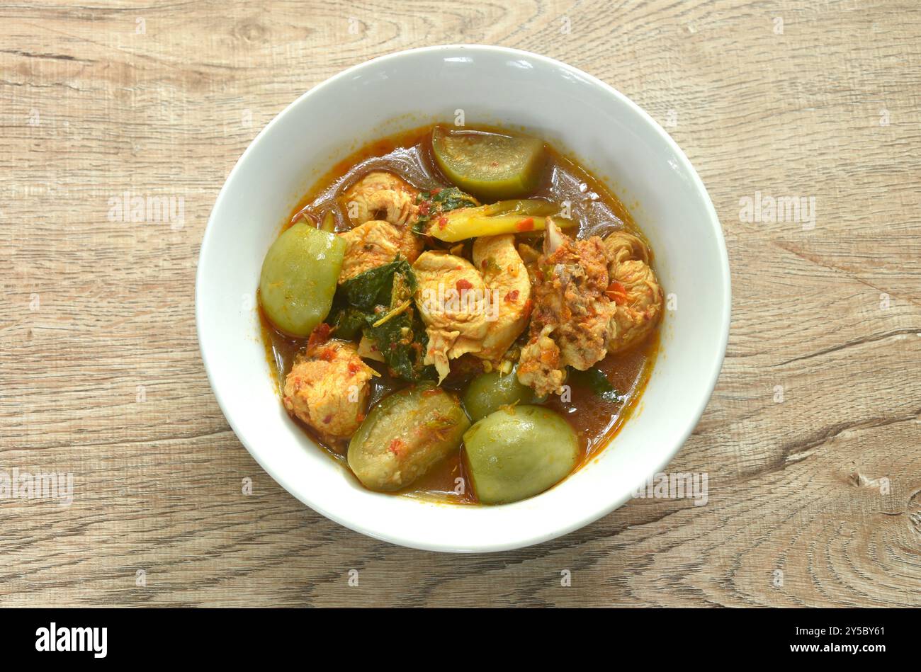 spicy boiled chicken with mixed vegetable in jungle curry soup Thai ...
