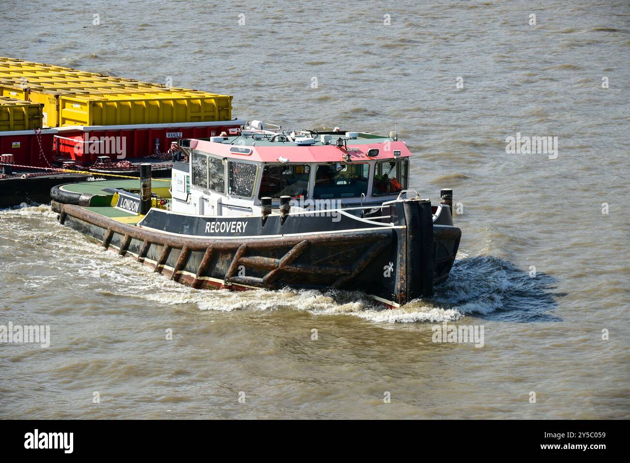 Tug 'Recovery' hauling barges of containers downstream on the River ...