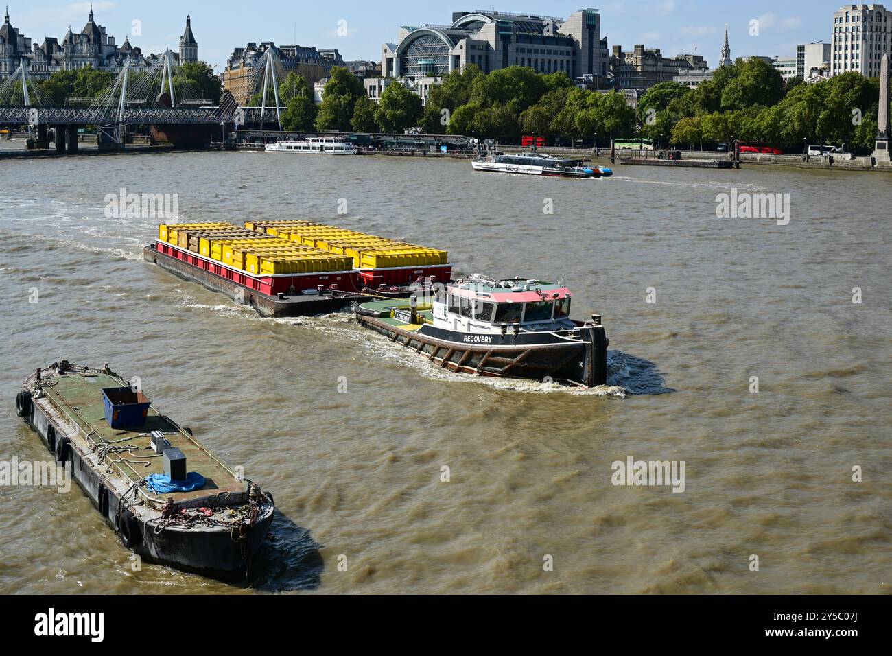 Tug 'Recovery' hauling barges of containers downstream, passing ...