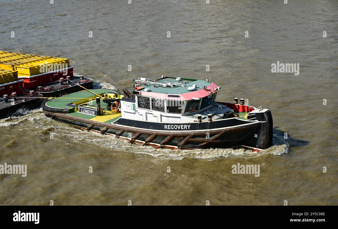 Tug 'Recovery' hauling barges of containers downstream on the River ...