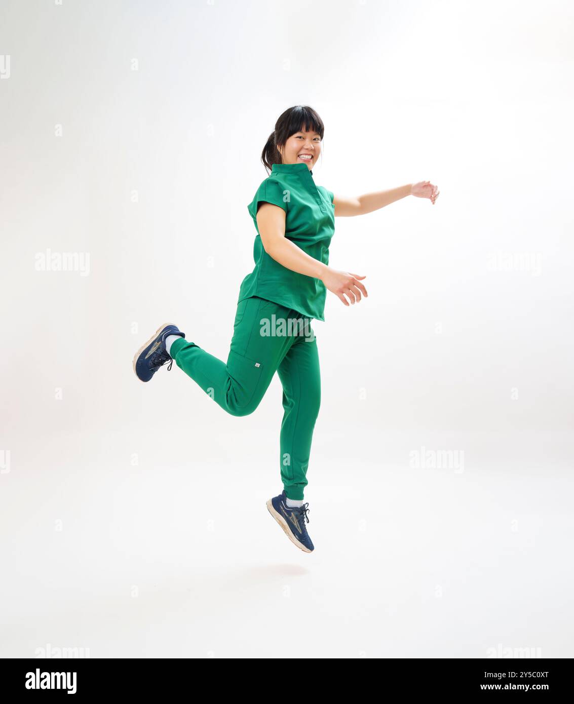 Young Asian Doctor Jumping Smiling Scrubs Green Studio White Background ...