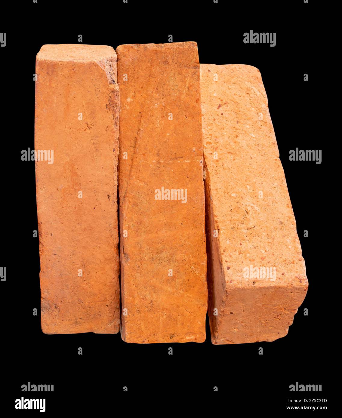 Side view of old red or orange bricks in stack is isolated on black ...