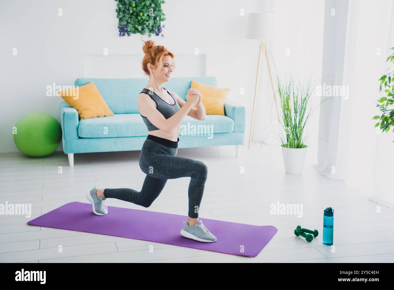 Full size photo of nice sporty young lady lunges fitness mat home gym ...