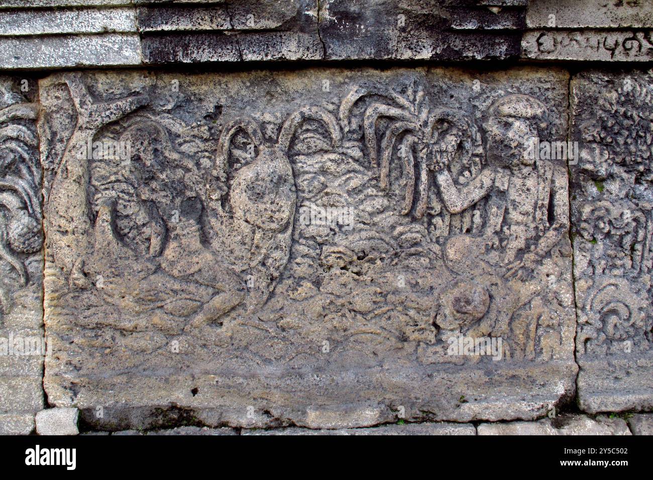 relief or carving on the stone wall at Penataran temple Stock Photo - Alamy