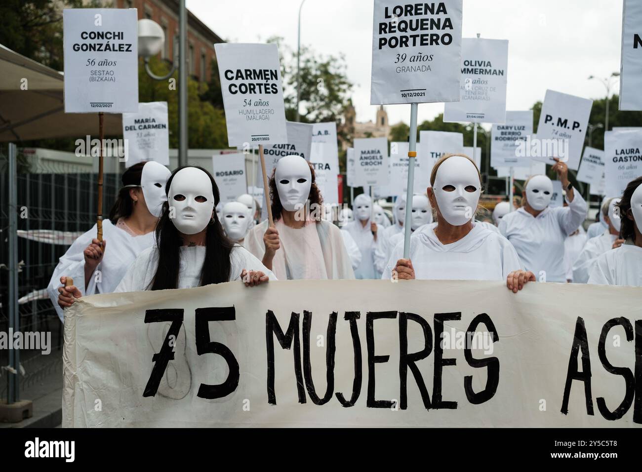 Women in white robes and masks during a demonstration to demand an end ...