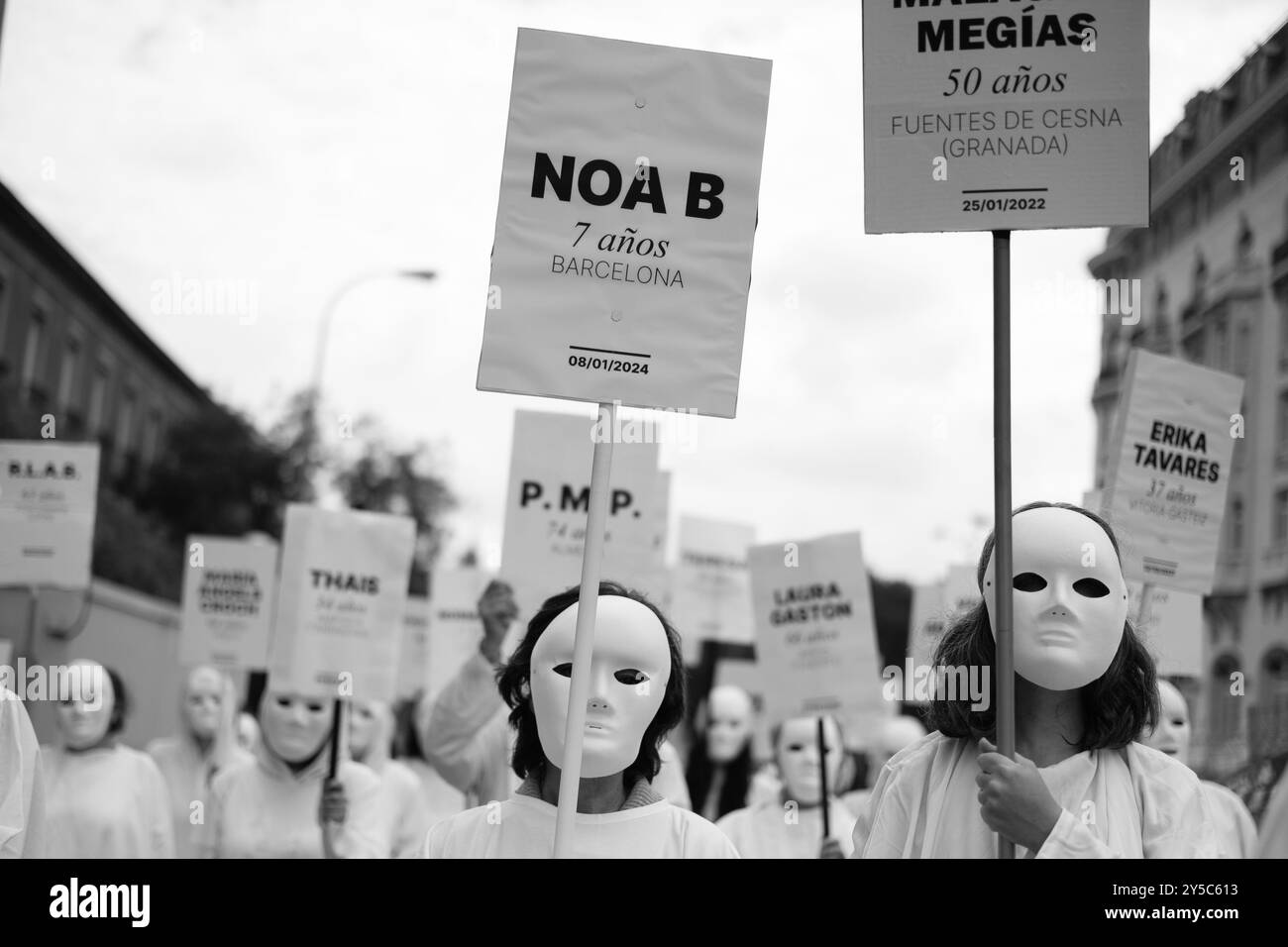 Women in white robes and masks during a demonstration to demand an end ...