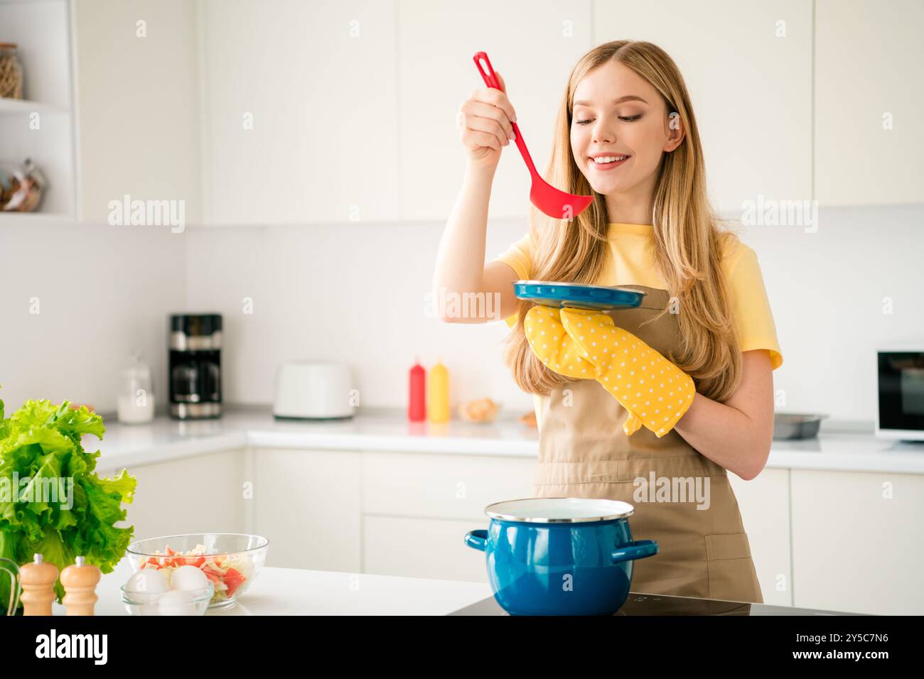 Photo of charming pretty nice girl cooking soup tasty food meal dinner ...