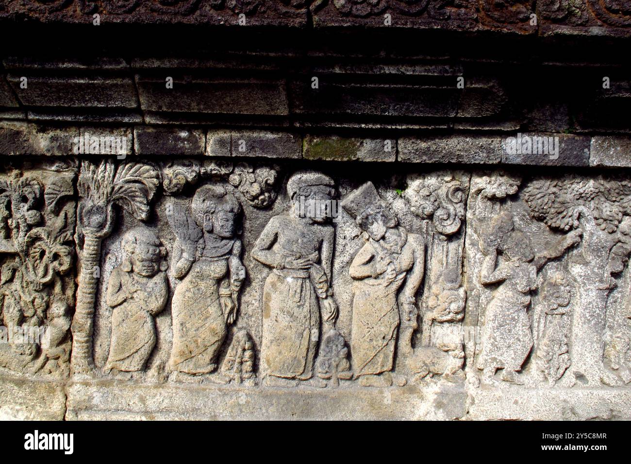 relief or carving on the stone wall at Penataran temple Stock Photo - Alamy