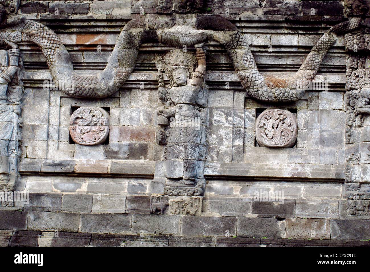 relief or carving on the stone wall at Penataran temple Stock Photo - Alamy
