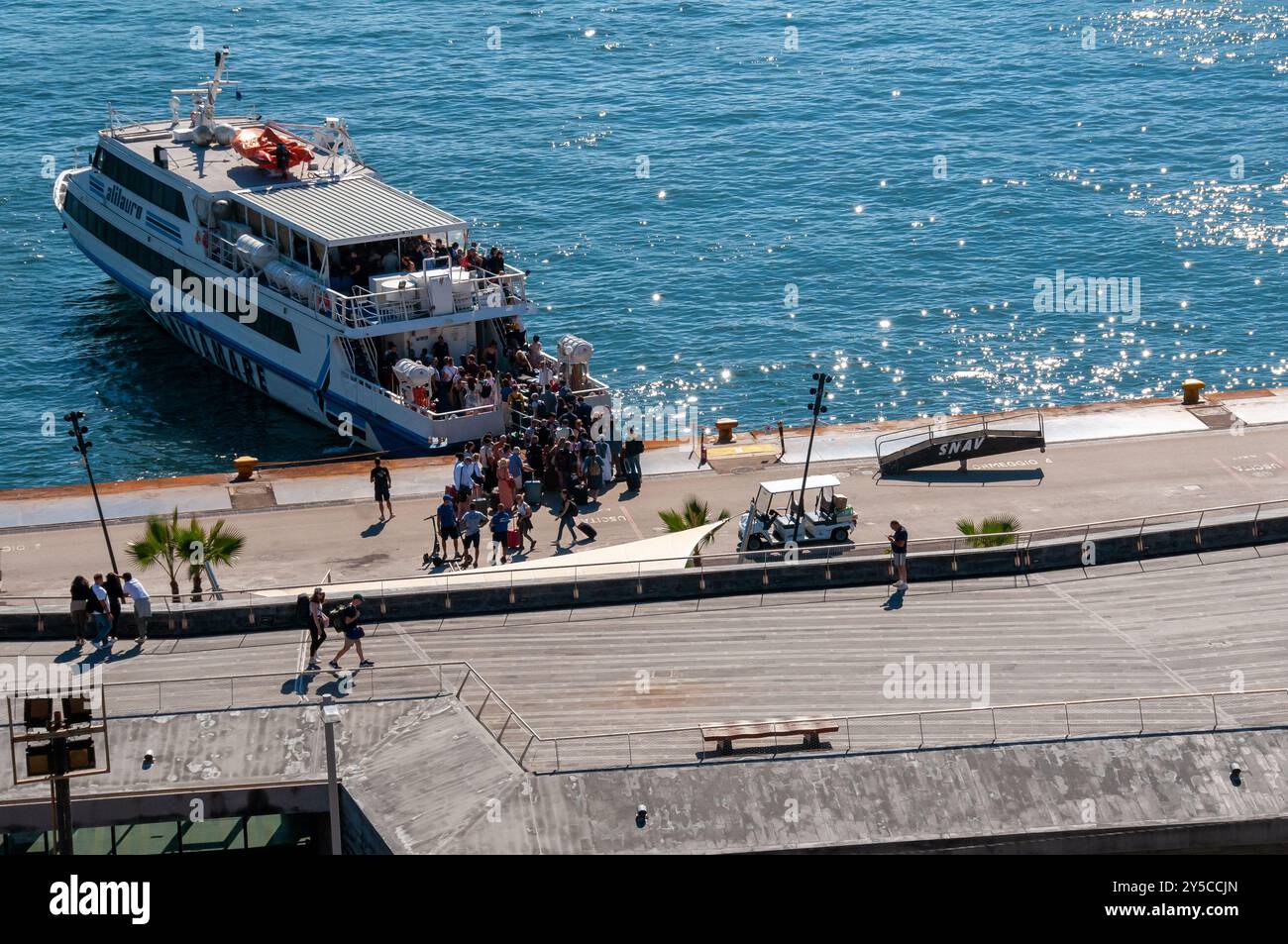Tourists boarding a hydrofoil at Molo Beverello in Naples taken from ...