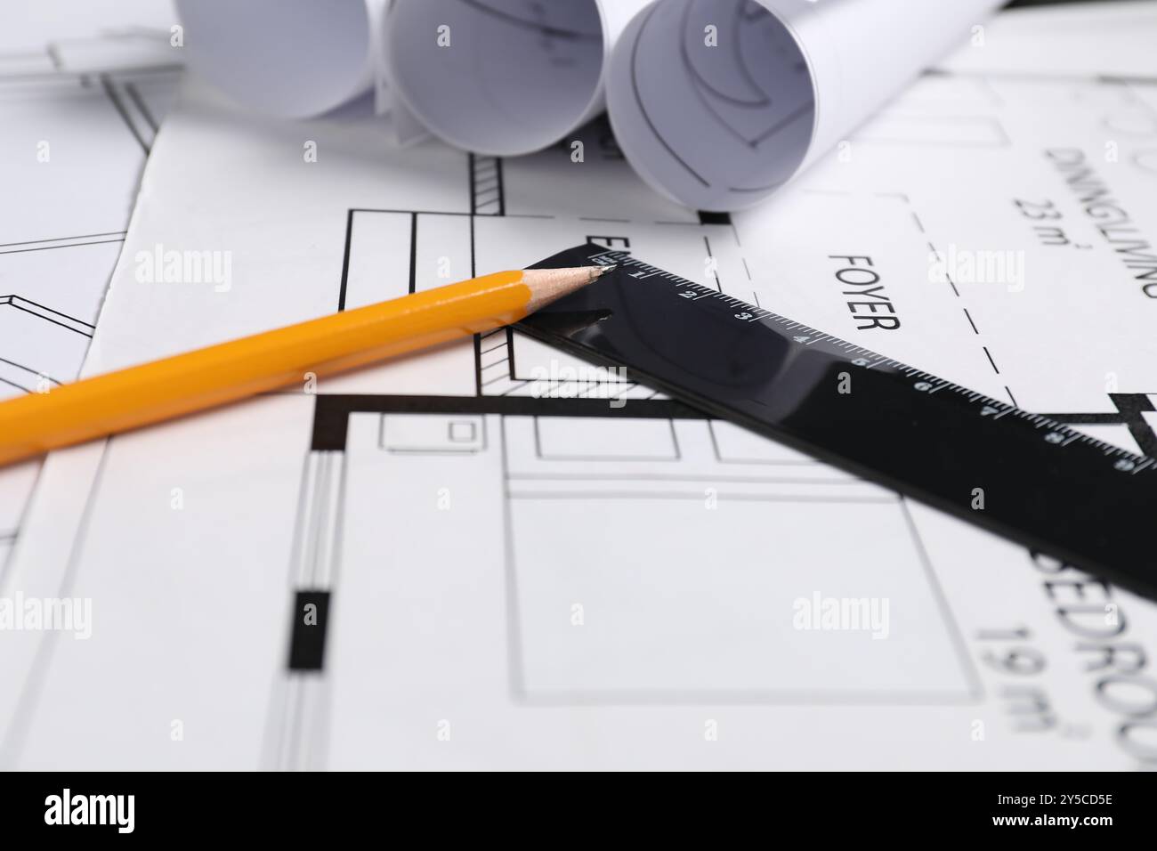 Different architectural drawings, ruler and pencil on table, closeup ...