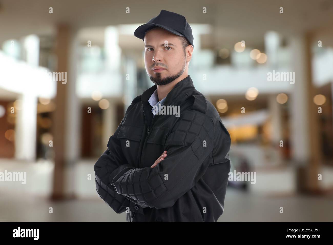 Portrait of confident security guard in shopping mall Stock Photo - Alamy