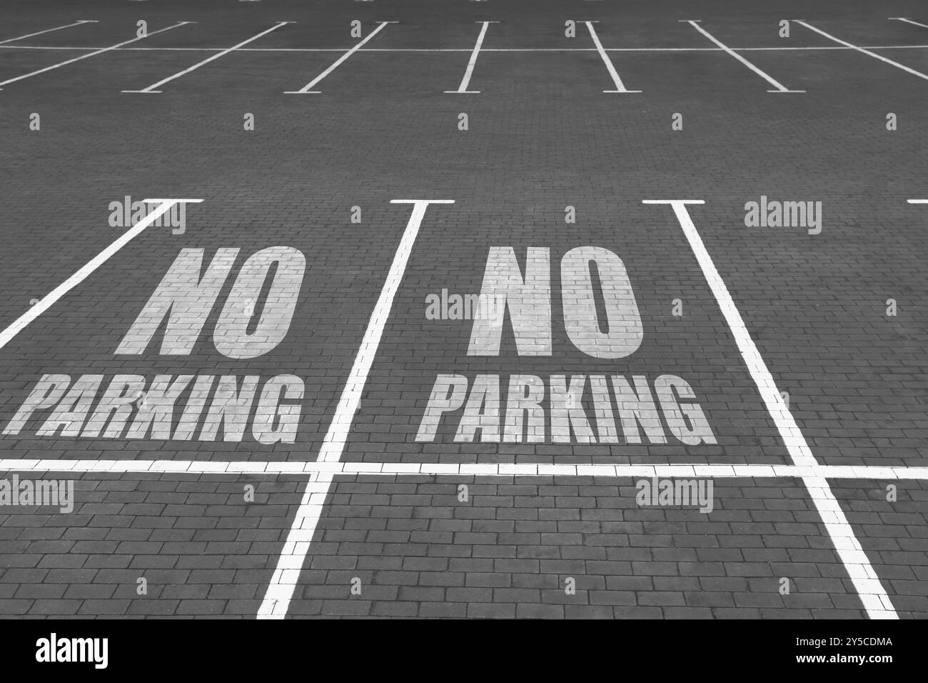 Empty outdoor parking lot with painted markings on brick pavement Stock ...