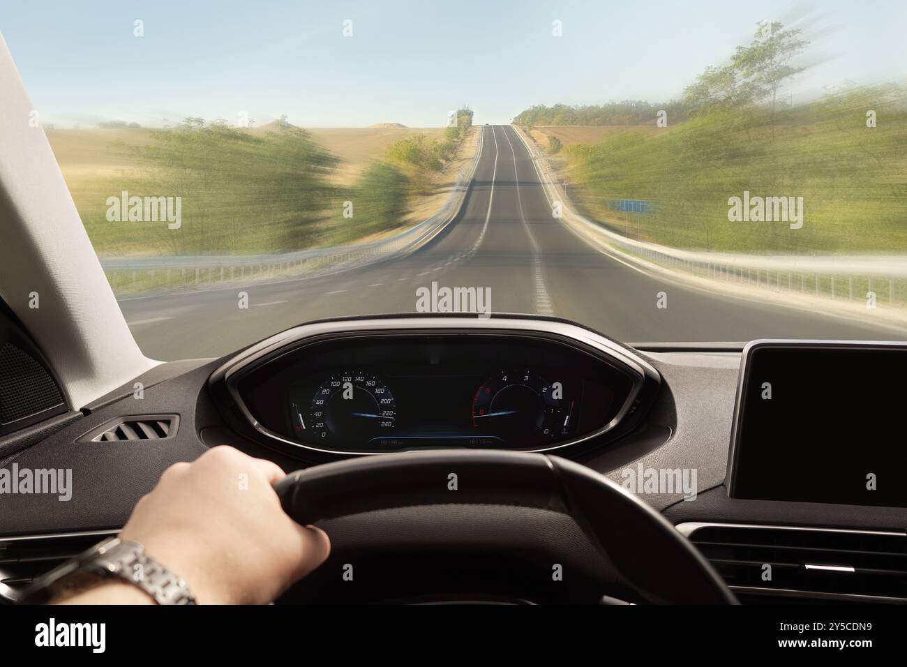 Man driving car on empty at high speed, first-person view. Motion blur ...