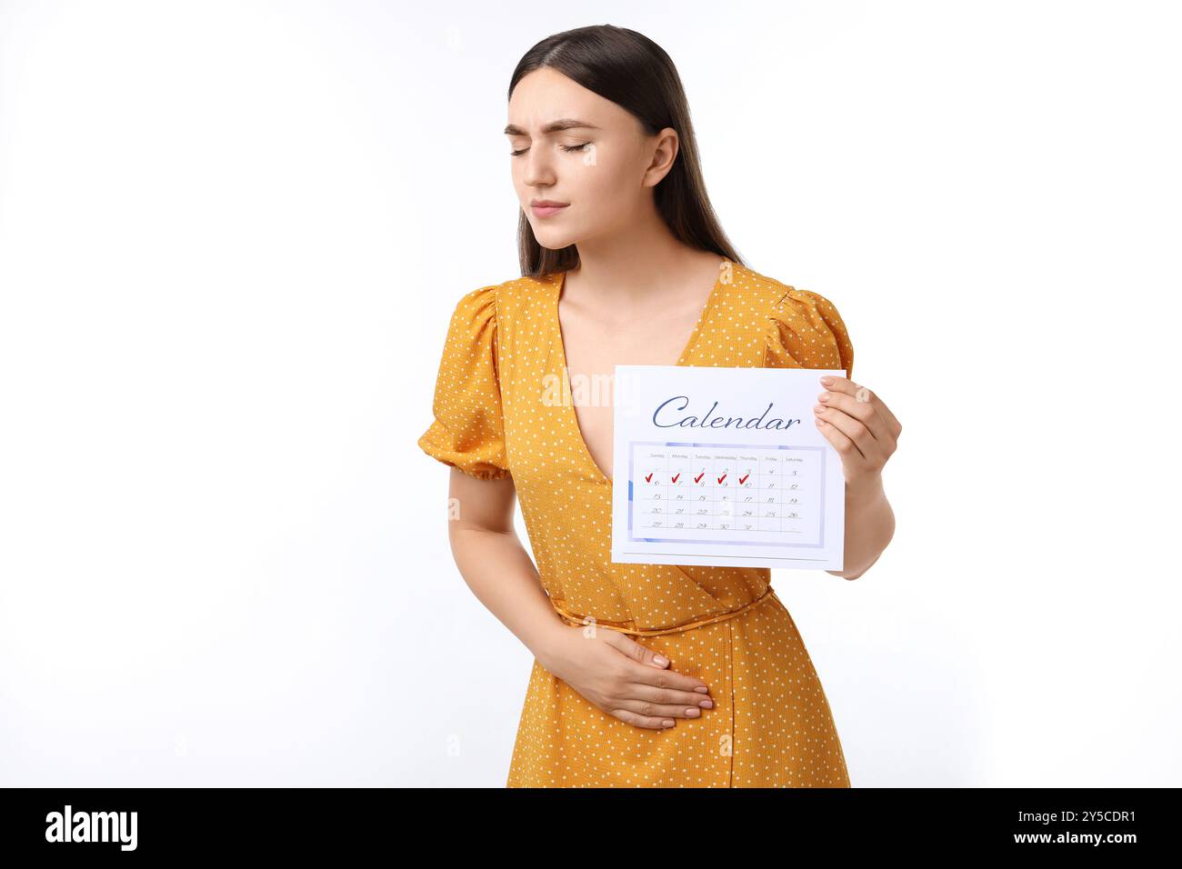Woman holding calendar with marked menstrual cycle days and suffering ...