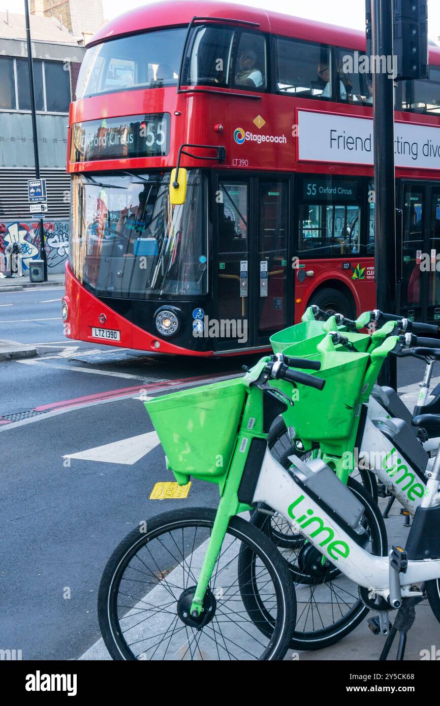 Lime e-bikes next to a red London bus in Old Street, Hackney, London ...