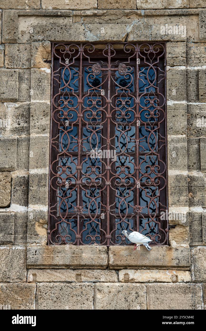 decorative wrought iron grill over stained glass window on historic ...