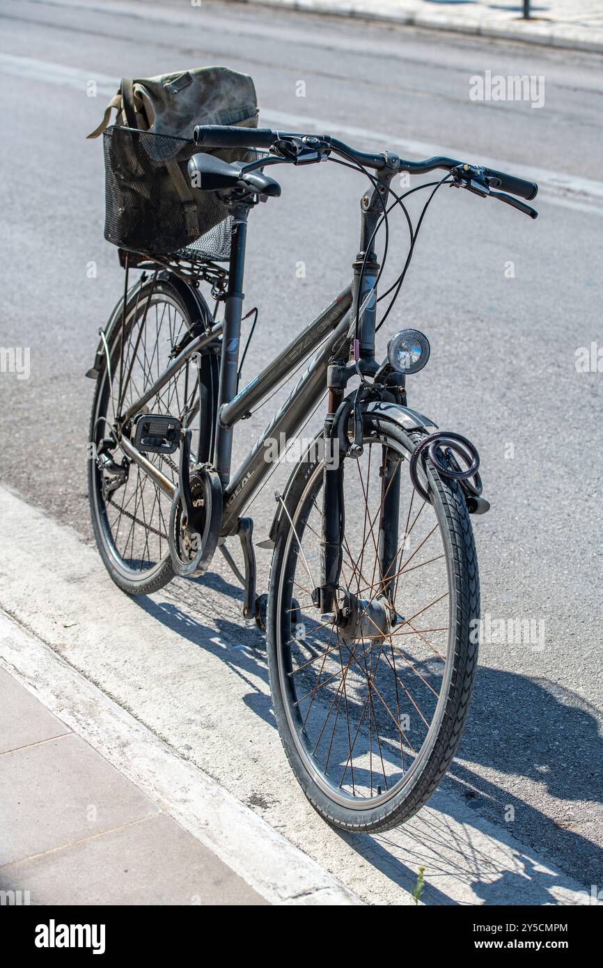 old fashioned bicycle at side of street, old style bicycle left at ...