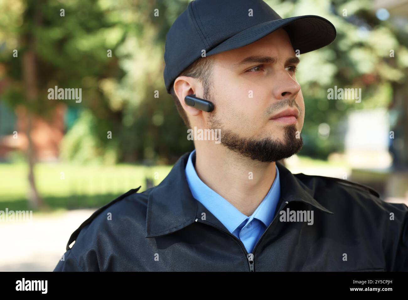 Security guard in uniform with earpiece outdoors Stock Photo - Alamy