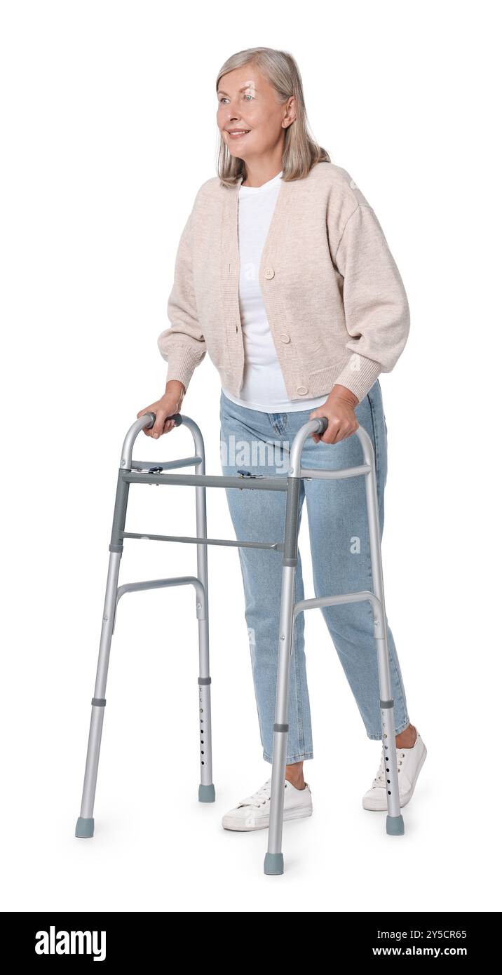 Senior woman using walking frame on white background Stock Photo - Alamy