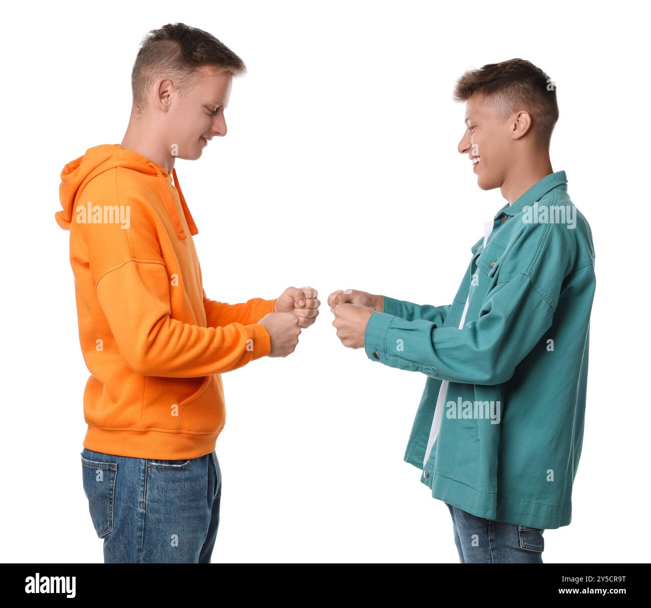 Two young brothers greeting on white background Stock Photo - Alamy