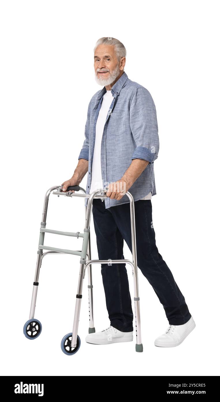 Senior man using walking frame on white background Stock Photo - Alamy