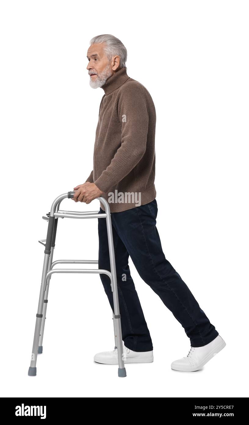 Senior man using walking frame on white background Stock Photo - Alamy