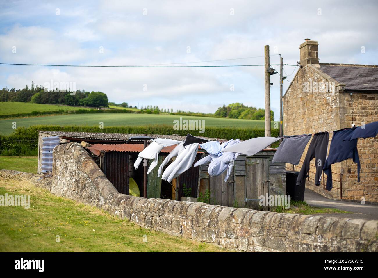 Clothes drying on a washing line, at a farmhouse in the UK Stock Photo ...