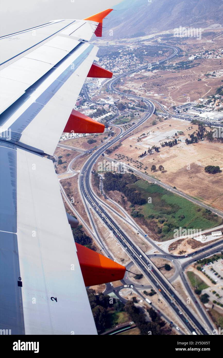 Above Malaga, Spain, highways weave through neighborhoods and ...