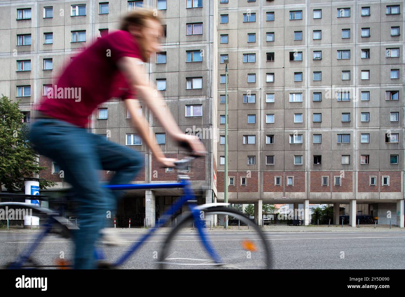 A cyclist pedals by a characteristic Socialist-era building in former ...