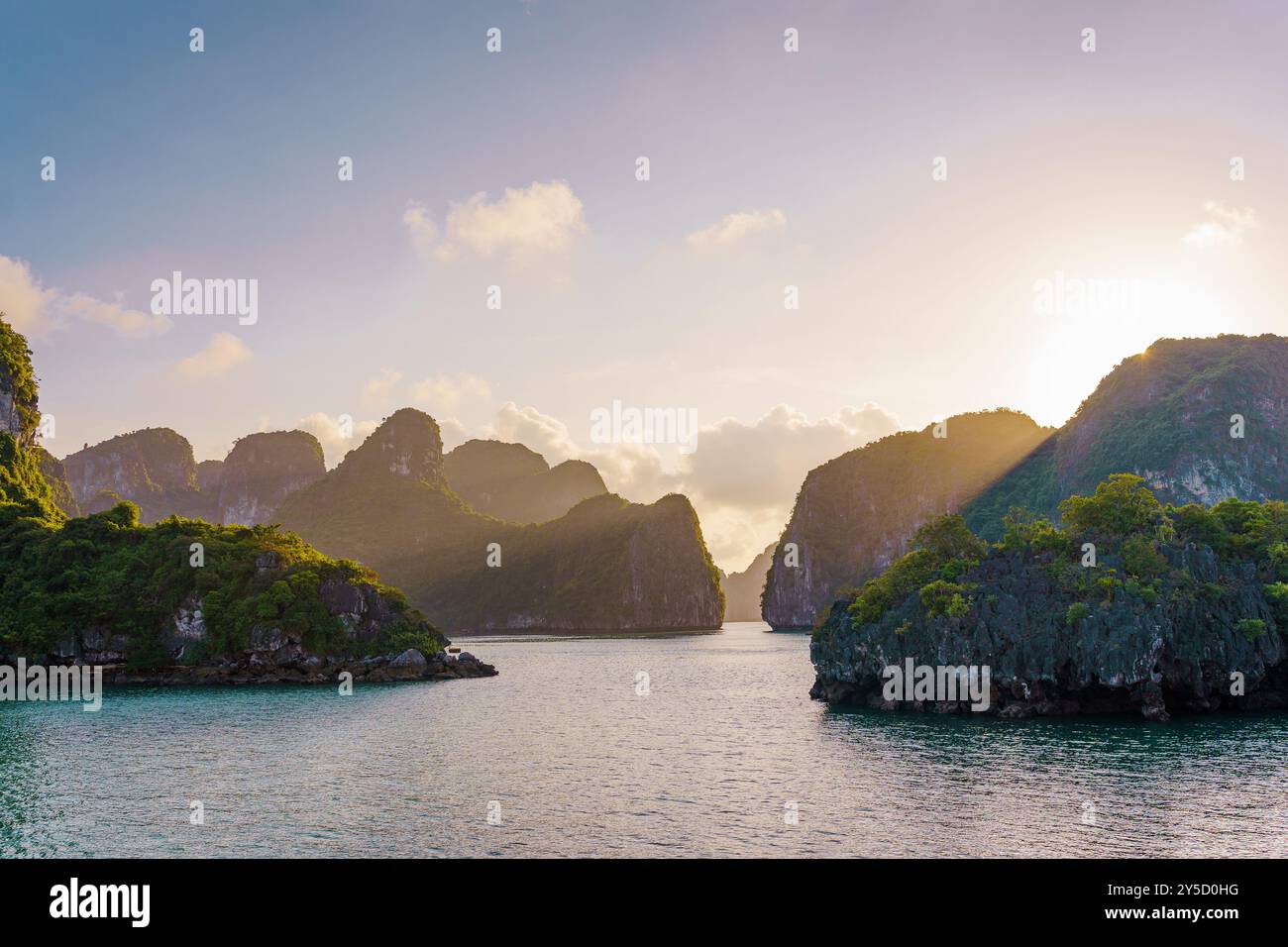 Ha Long Bay landscape view at sunset with sun rays through limestone ...